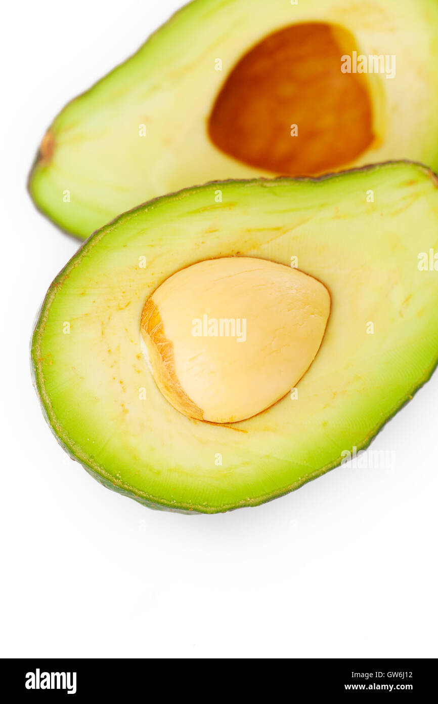 two halves of avocado isolated on white Stock Photo - Alamy