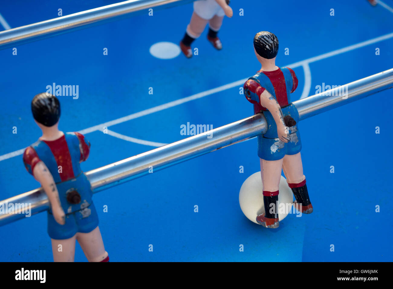 Detail of figure of table football players, painted with red and blue ...