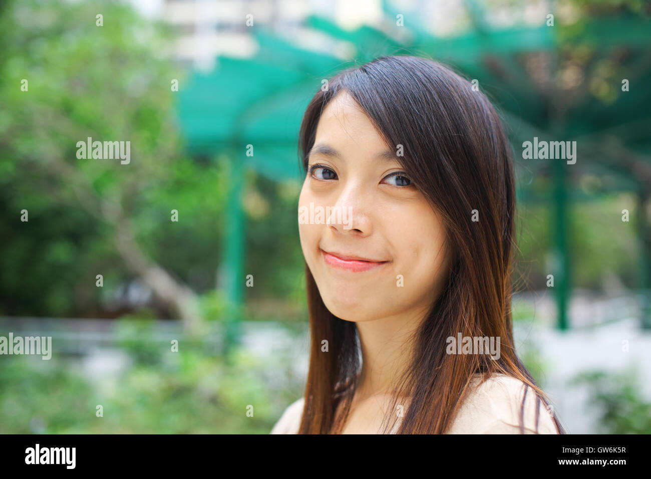 young woman smiling friendly Stock Photo - Alamy