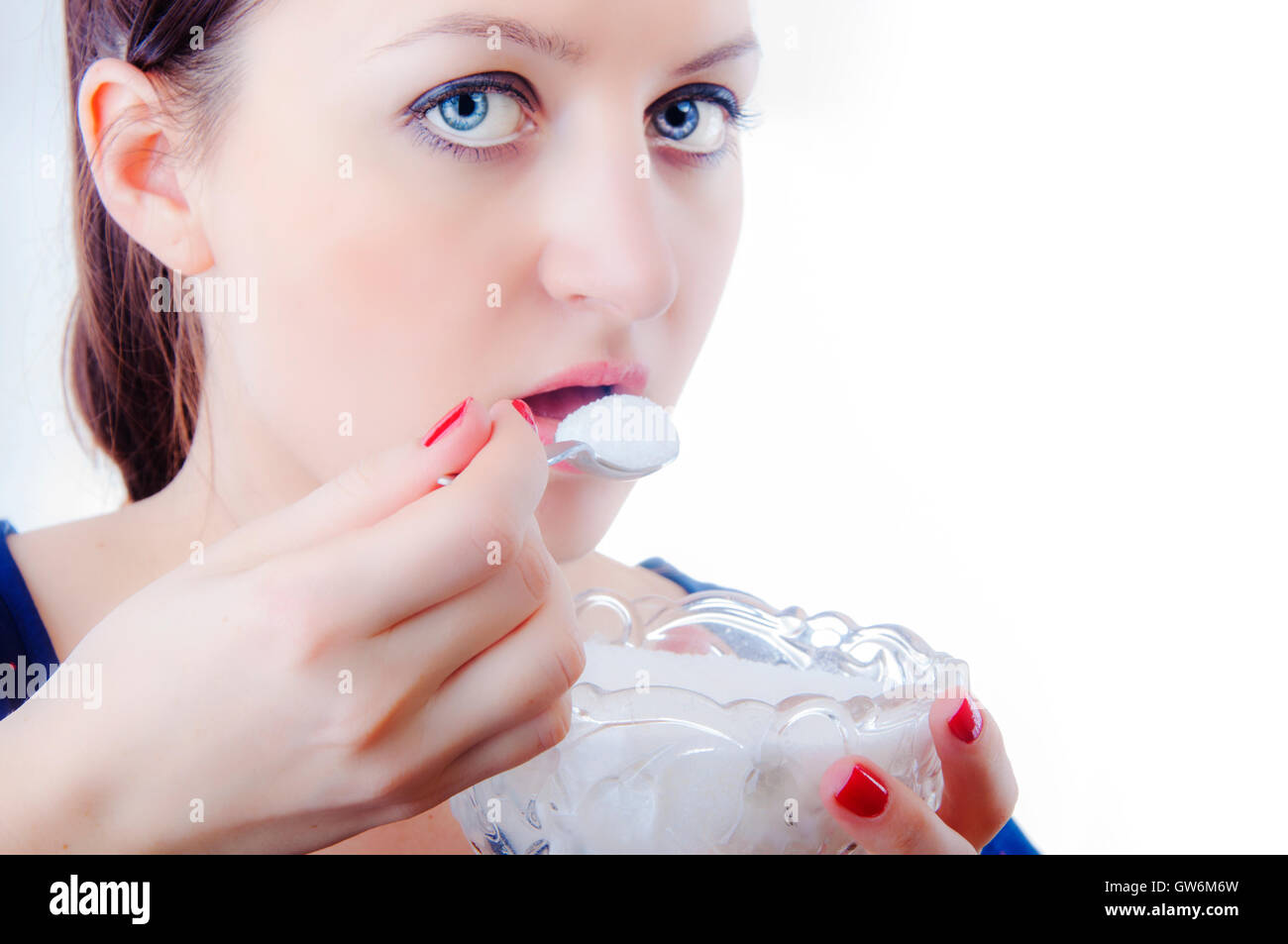 Woman eating sugar Stock Photo - Alamy