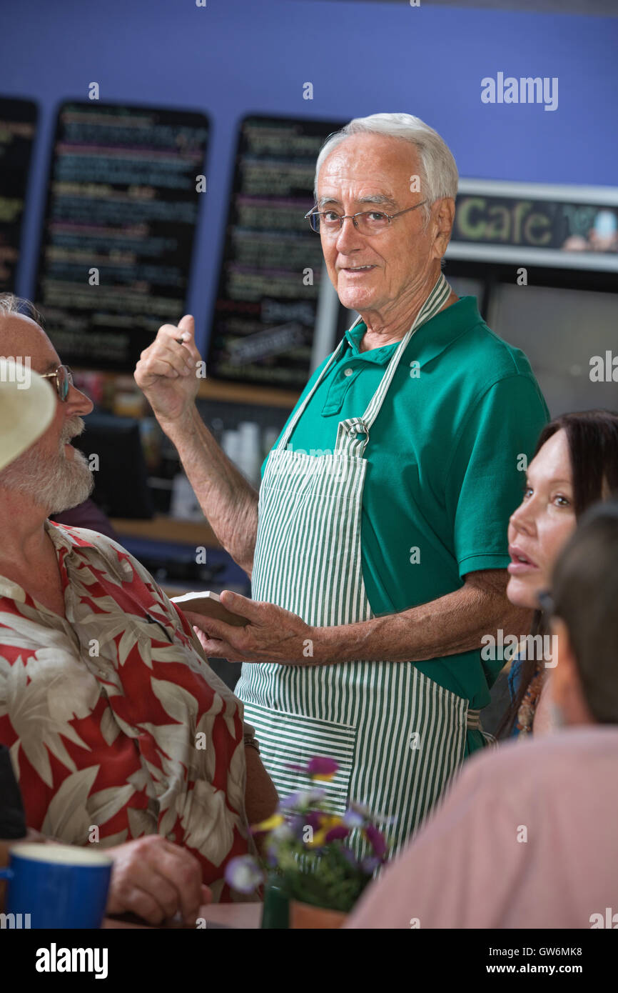 Handsome Host with Patrons Stock Photo - Alamy