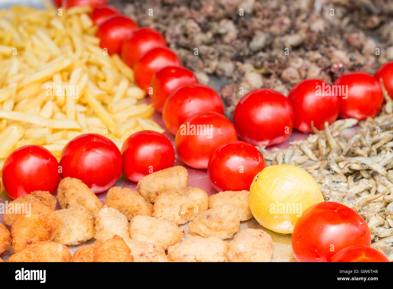 Different kind of food separated by a tomatoes line Stock Photo - Alamy