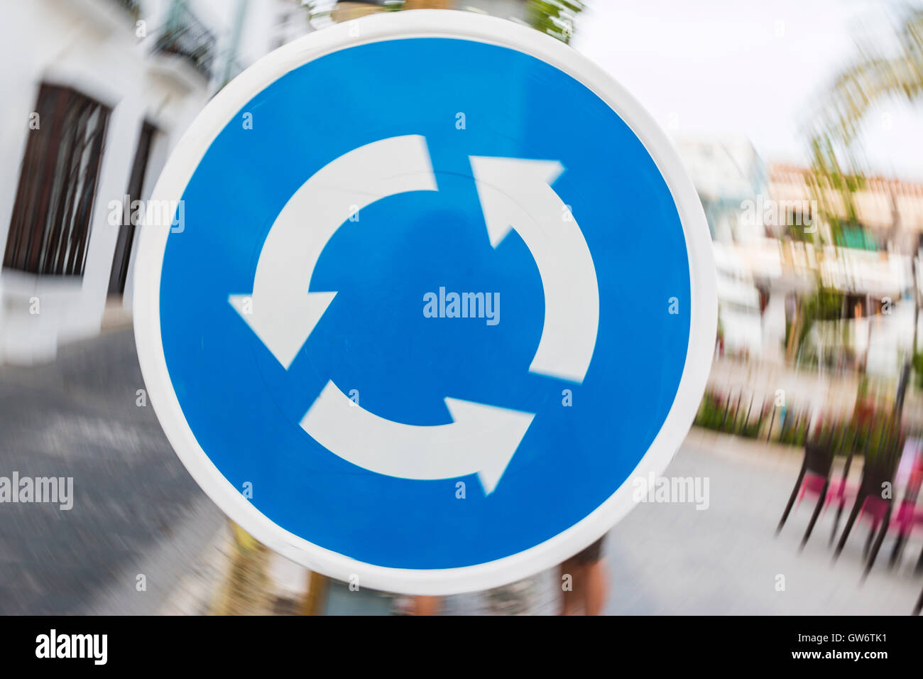 Blue roundabout sign abstract turning blurred motion Stock Photo - Alamy