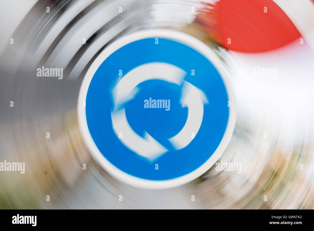 Blue roundabout sign abstract turning blurred motion Stock Photo - Alamy