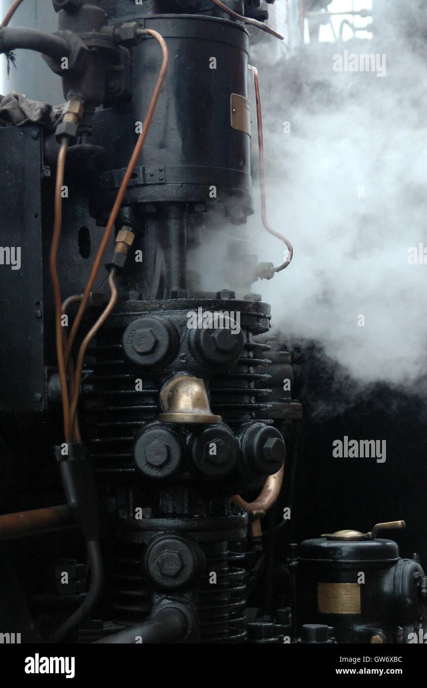 Closeup of steam locomotive, featuring technical parts with emerging ...
