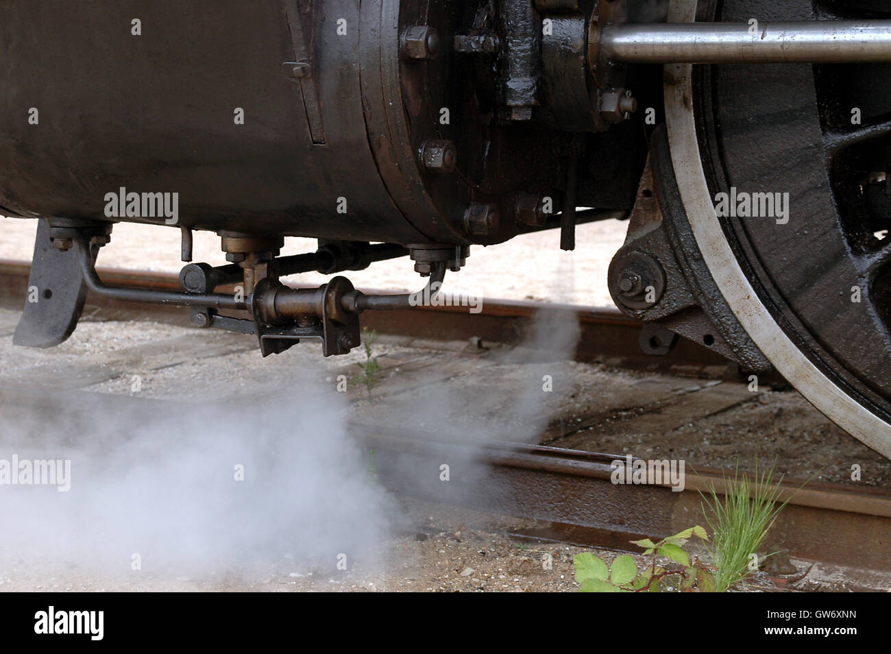 Closeup of steam locomotive, featuring technical parts with emerging ...