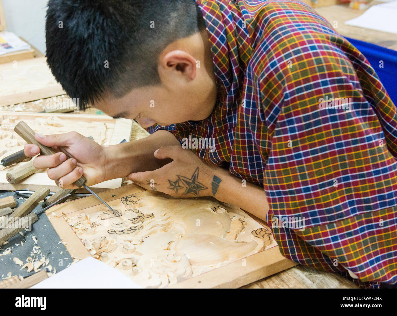 Student carving a piece at Zorig Chusum, where Bhutan's 13 traditional ...
