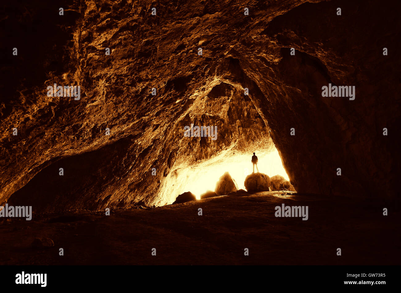 man silhouette at cave entrance Stock Photo - Alamy