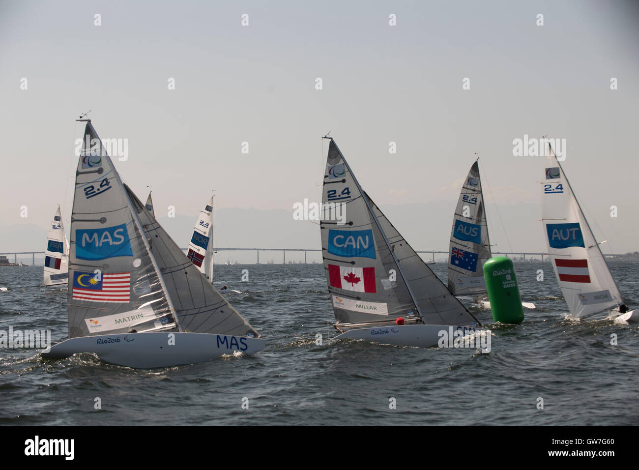 Single-handed sailors maneuver their 2.4-meter keelboat during sailing ...