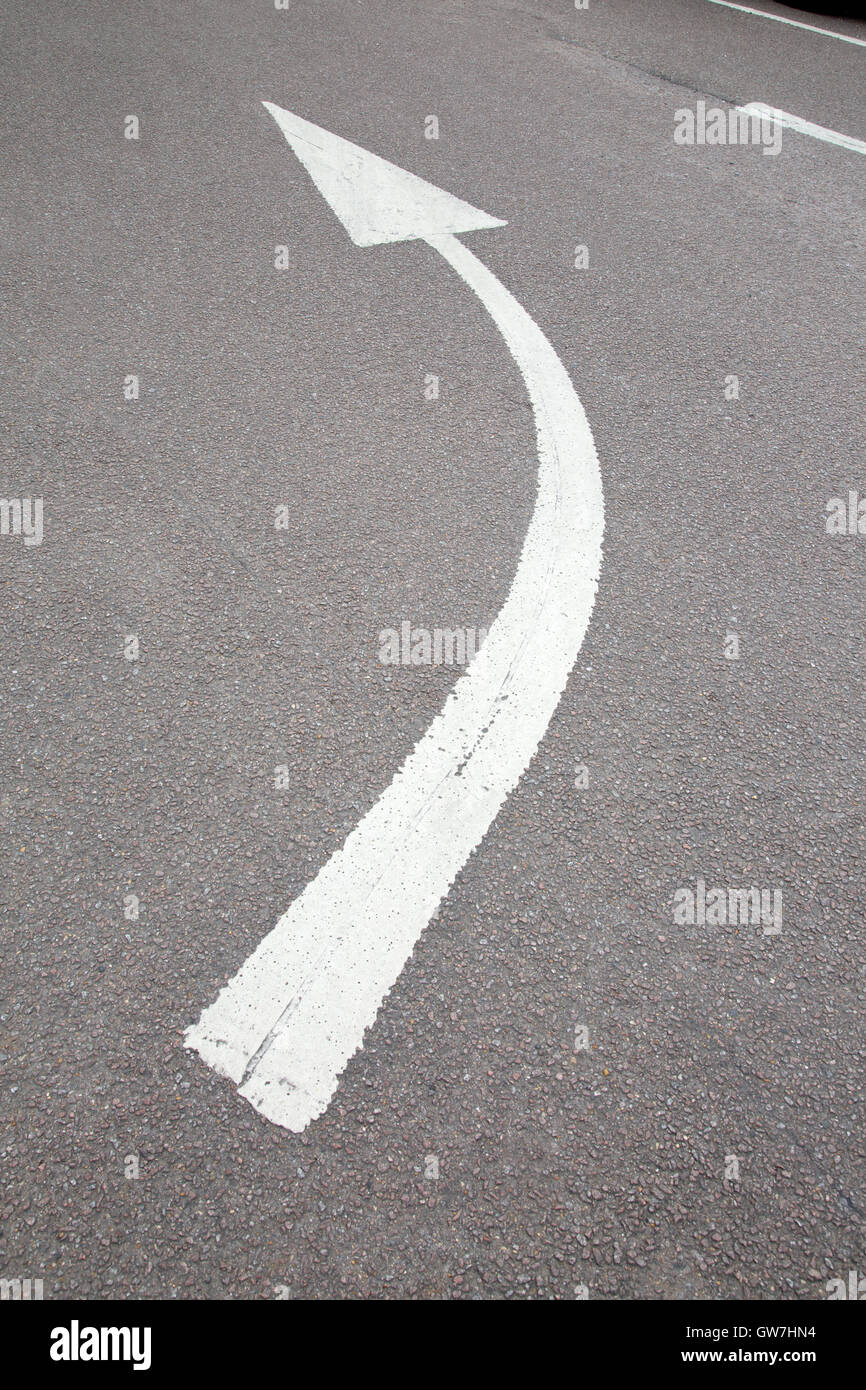 Curved Arrow Sign on Street Surface Stock Photo - Alamy