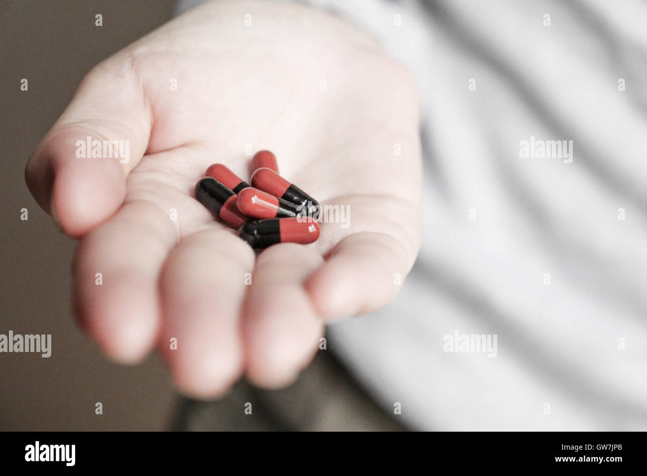 Medicine pills or capsules in hand, palm or fingers. Drug prescription ...