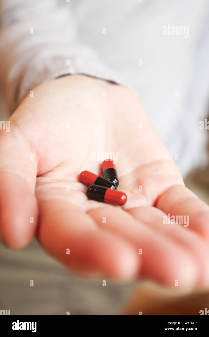 Medicine pills or capsules in hand, palm or fingers. Drug prescription ...