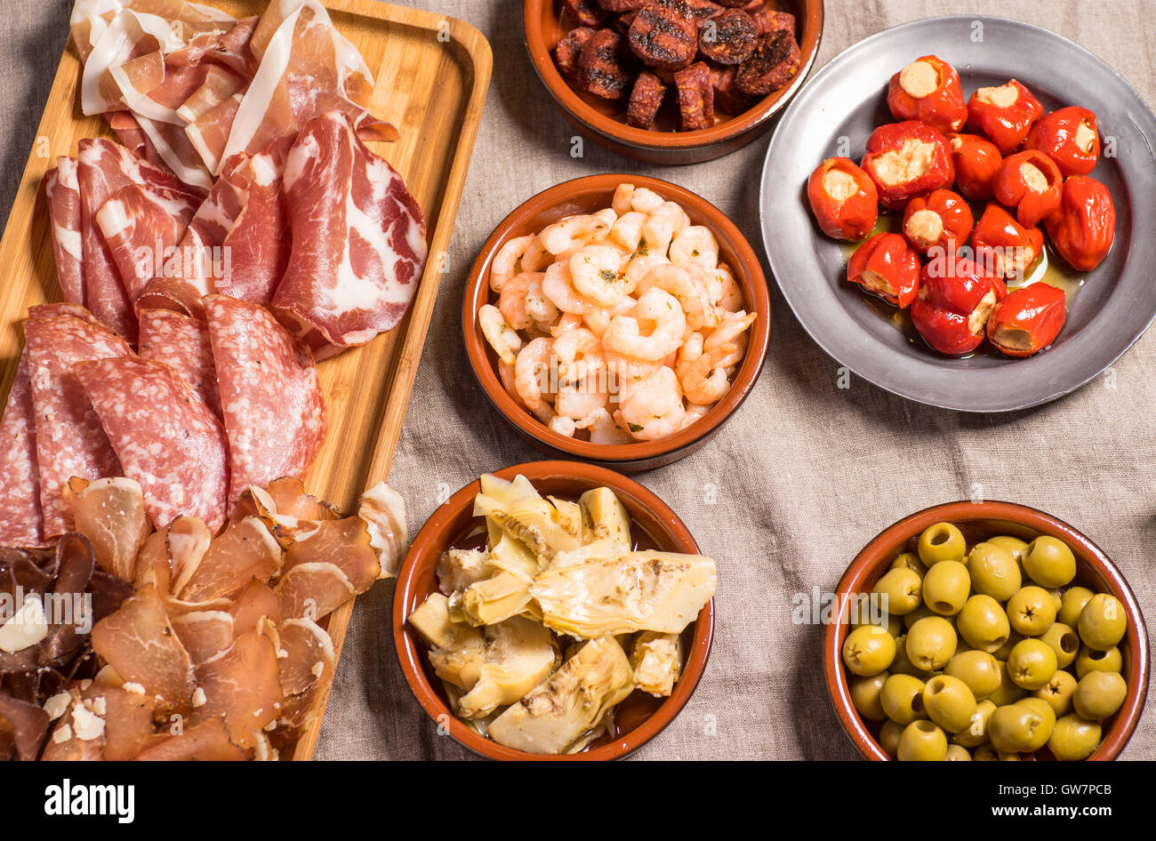 Tapas food, served in small bowls cold meat, goat cheese. A meal for ...