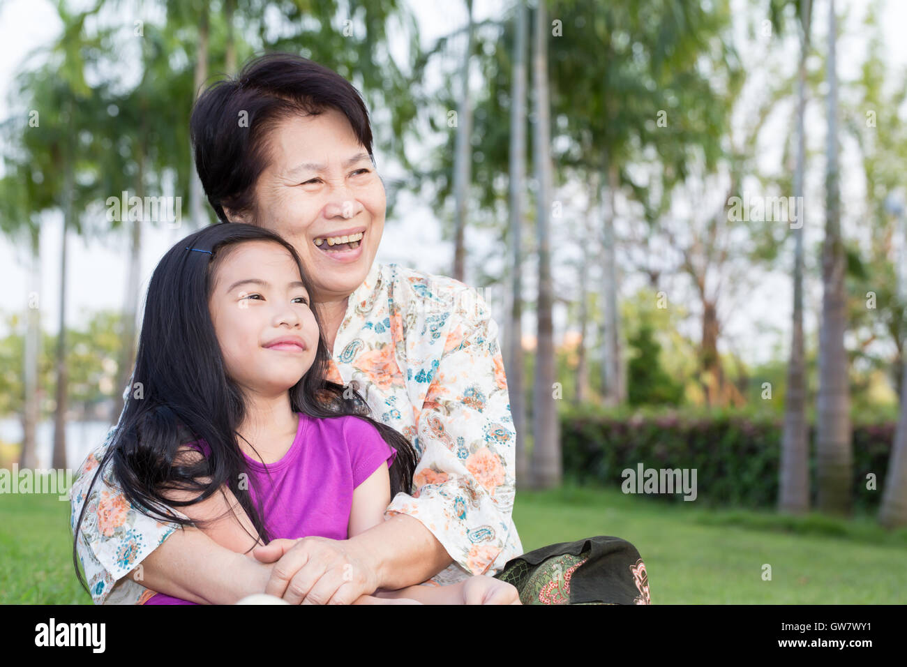 Grandma and grandchild hugging in the park Stock Photo - Alamy