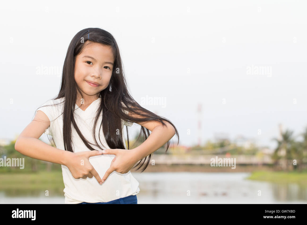 Young Asian girl making heart with hands Stock Photo - Alamy