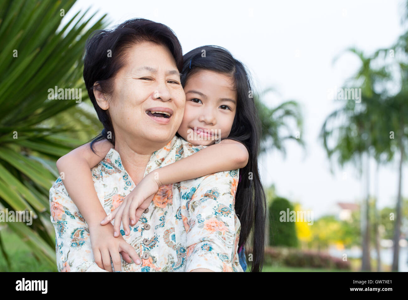 Grandma and grandchild hugging in the park Stock Photo - Alamy
