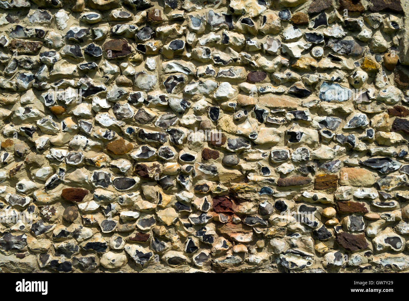 Decorative flint built wall on Cranbourne village church, Dorset, UK ...