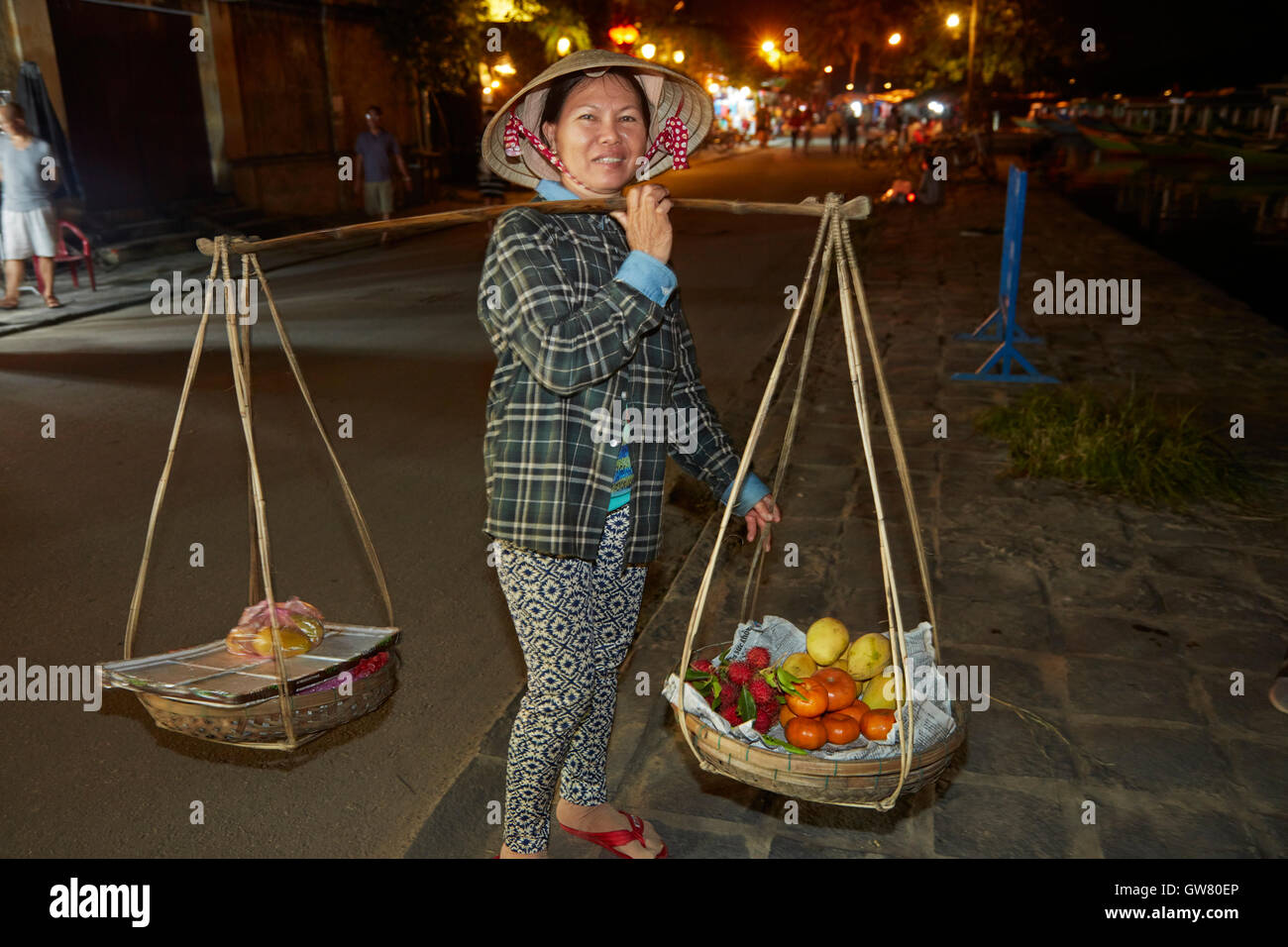 Vietnamese woman carrying produce on a bamboo yoke, Hoi An (UNESCO ...