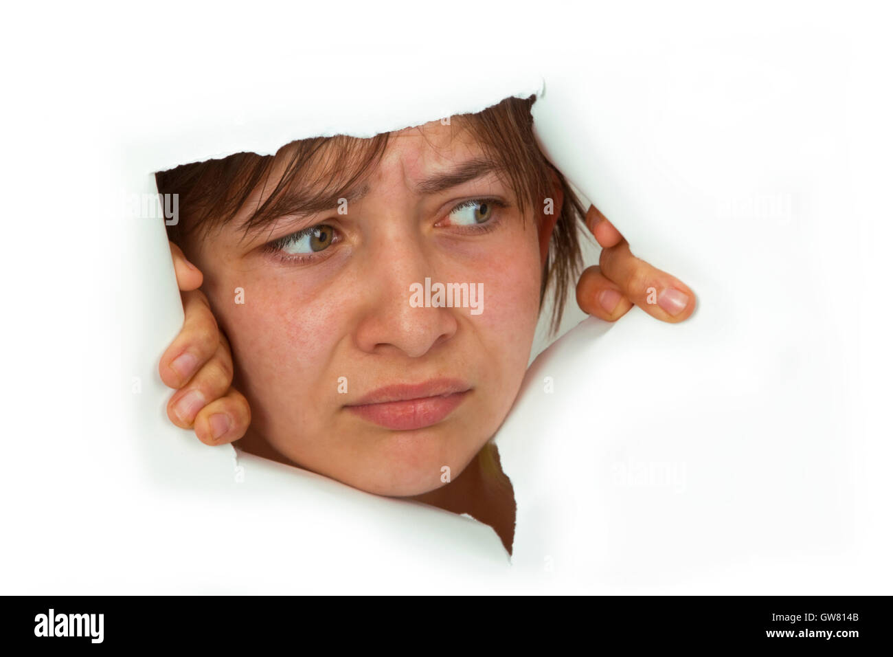 Young Woman is looking out of cutted paper Stock Photo - Alamy