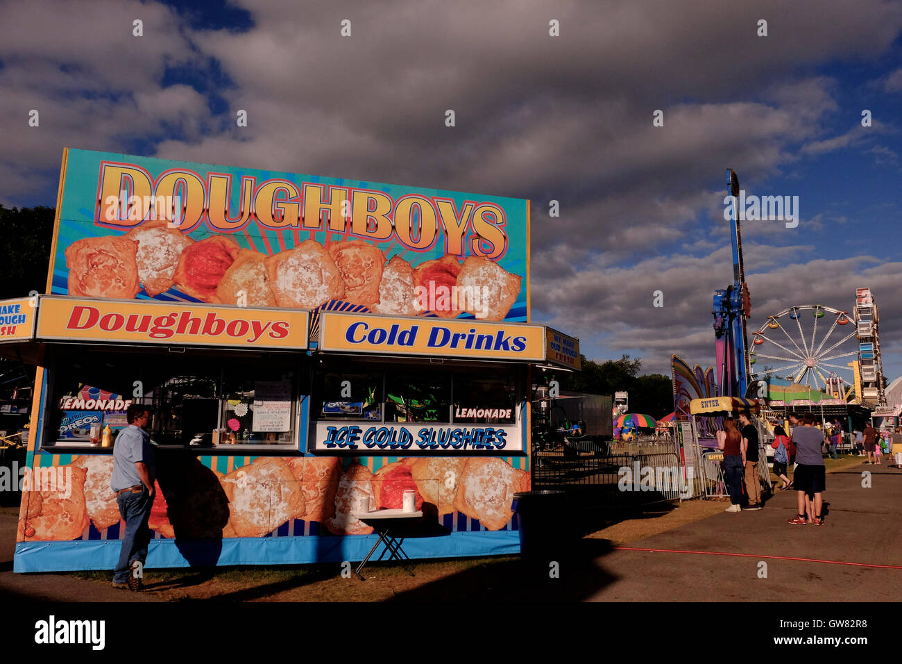 County fair midway with ferris wheel, rides and food stalls Stock Photo ...