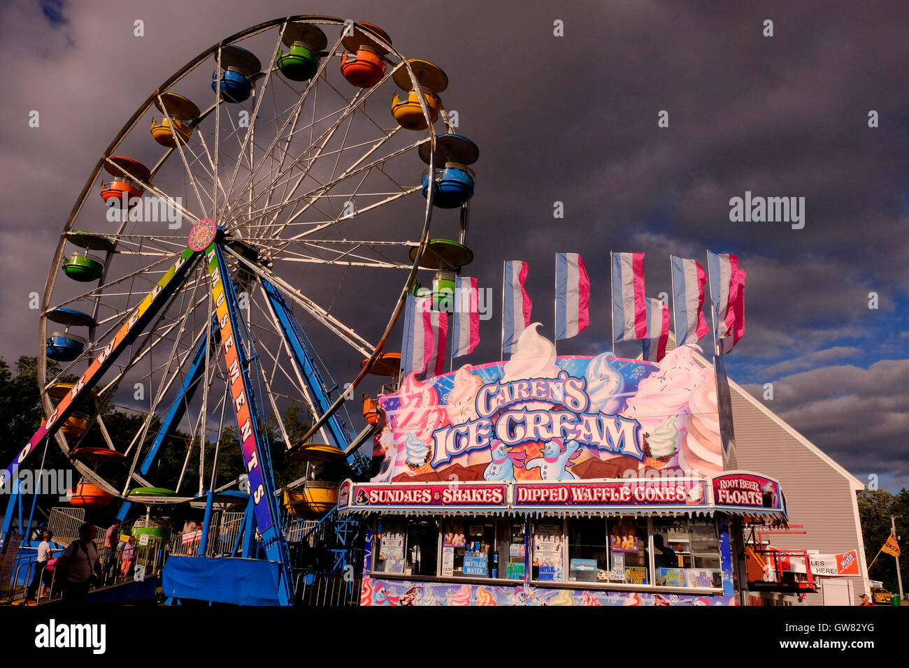 County fair midway with ferris wheel, rides and food stalls Stock Photo ...