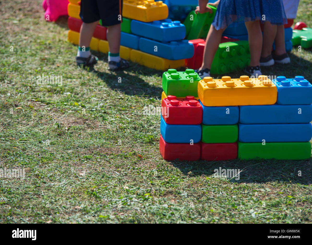 Kids play with bricks in the garden Stock Photo - Alamy