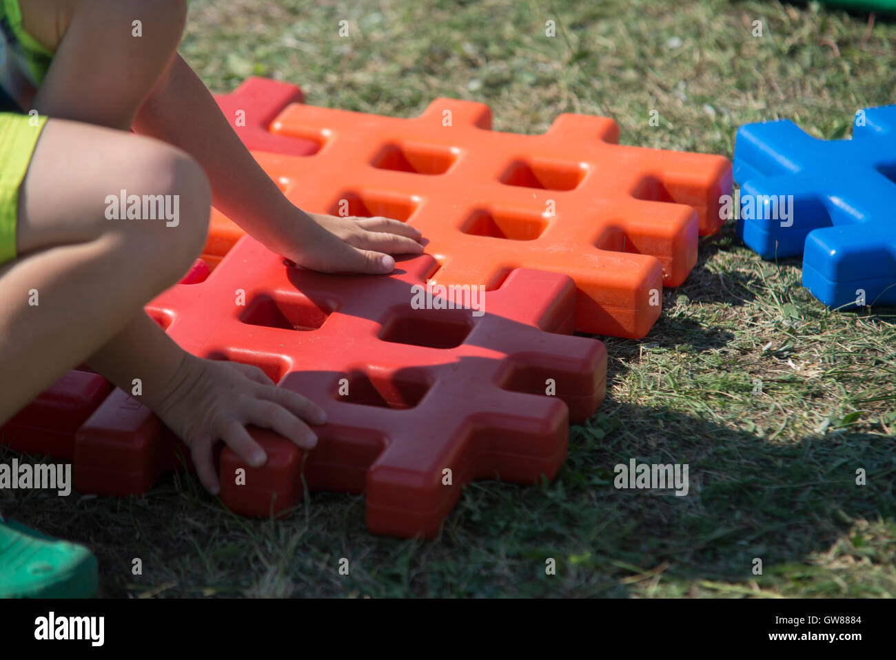 young boy play with bricks in the garden Stock Photo - Alamy