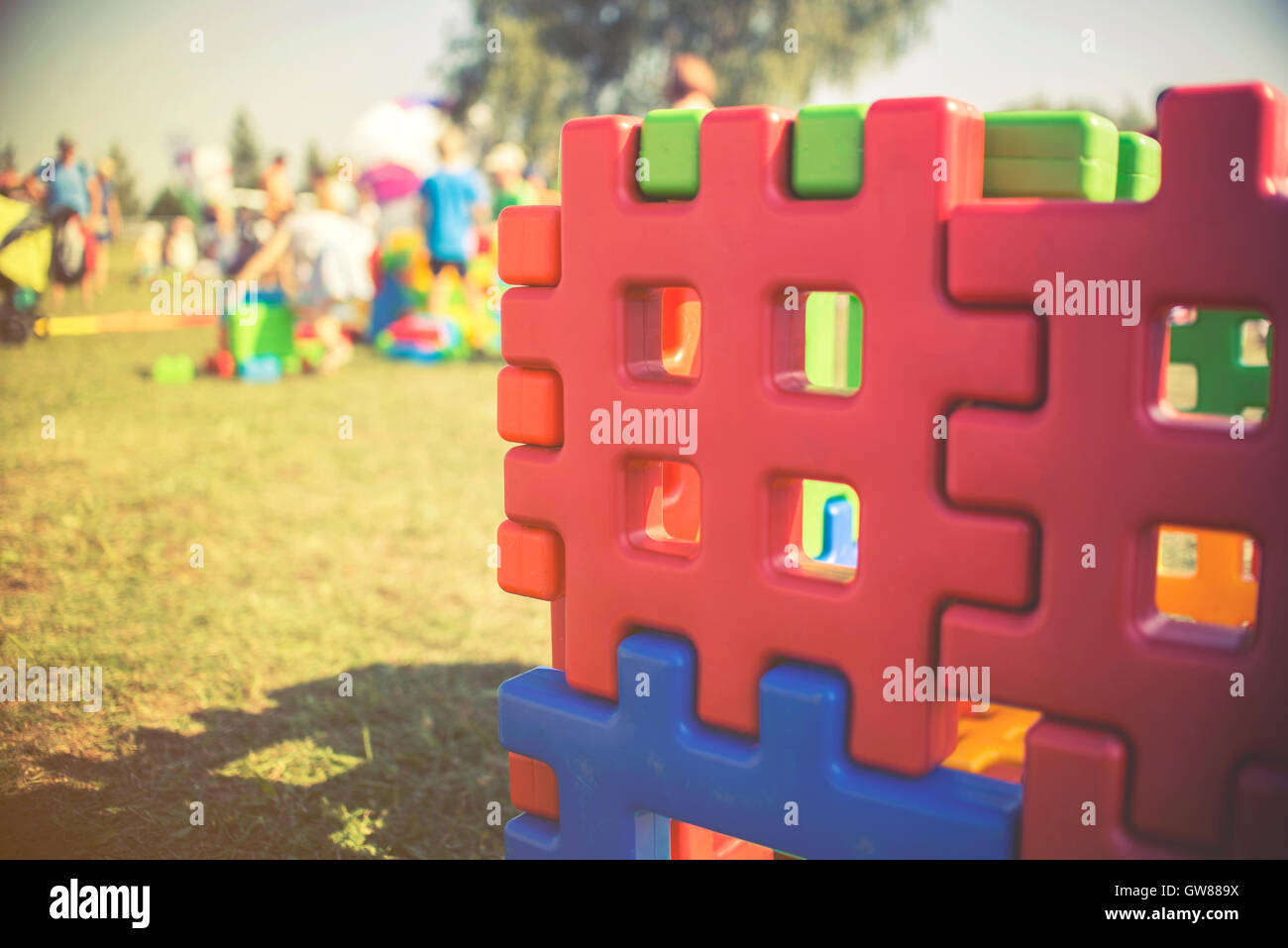 kids play with bricks in the garden, vintage effect Stock Photo - Alamy