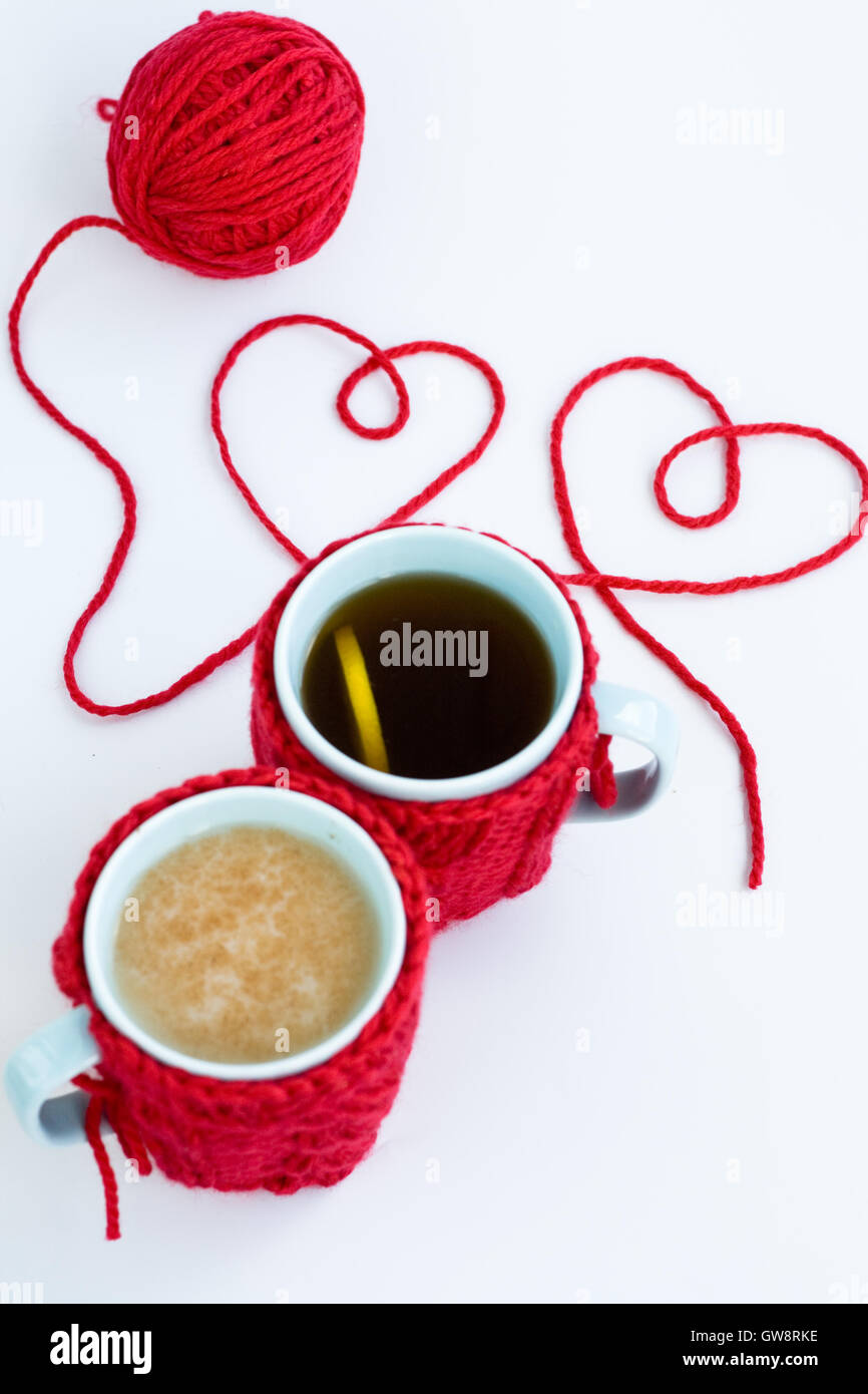Two blue cups in knitted covers and and two hearts from threads Stock ...