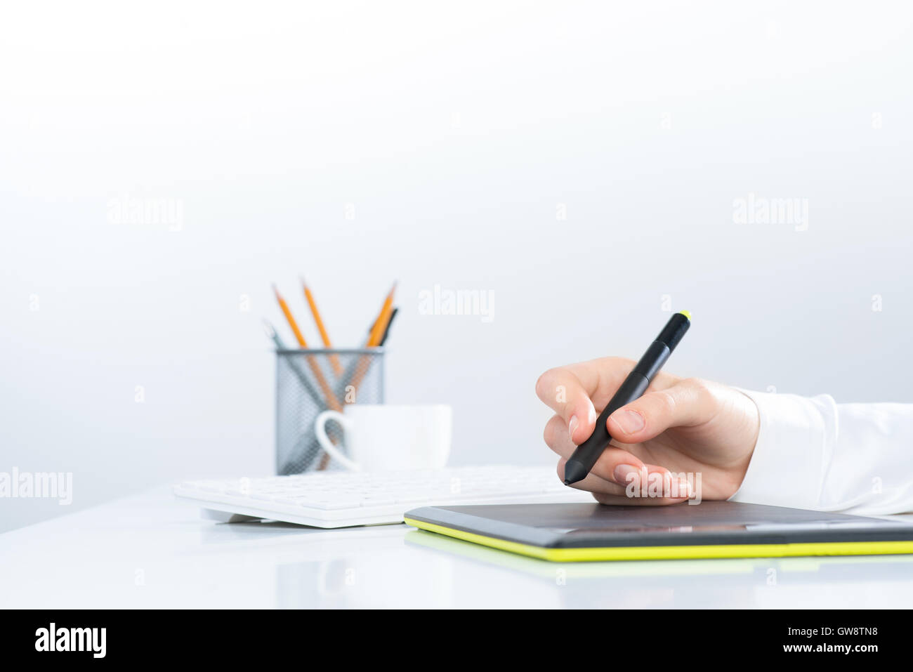 Designer hand drawing a graph on the tablet Stock Photo - Alamy