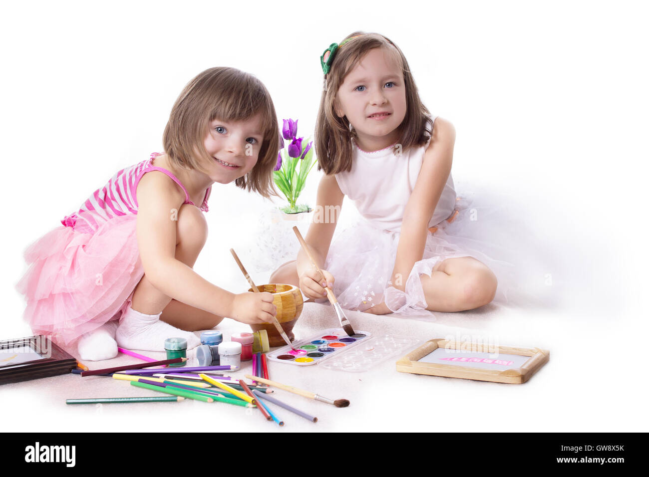 Two little girls drawing with paint Stock Photo - Alamy