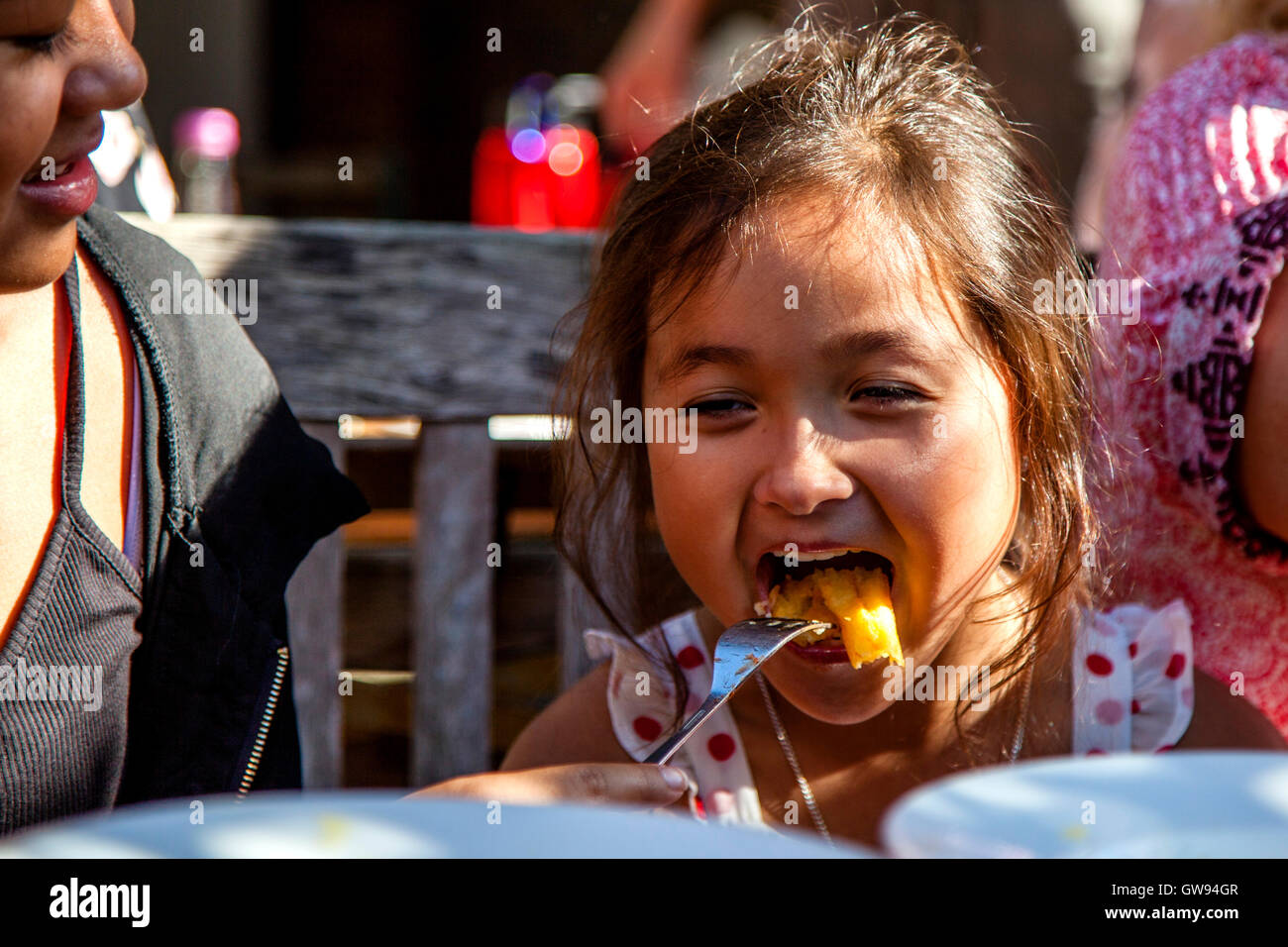 A Little Girl Eating Chips, Brighton, Sussex, UK Stock Photo - Alamy