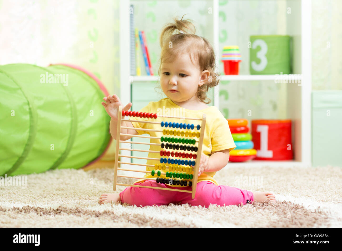 Child girl playing with abacus, early learning Stock Photo - Alamy