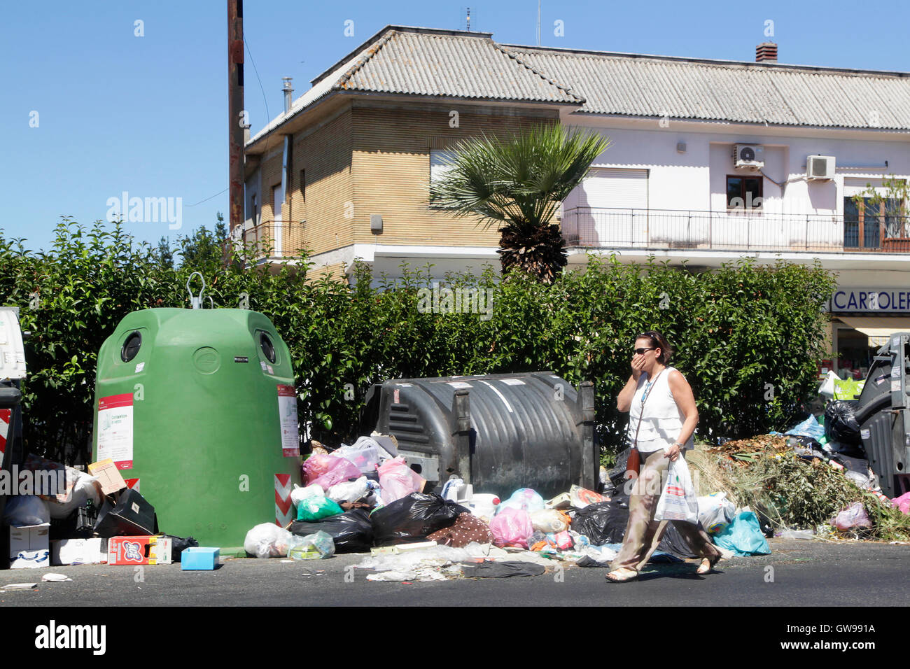 Pedestrian walks by uncollected rubbish in a street of Rome, Italy ...