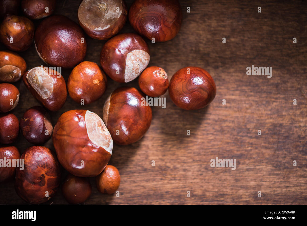 Autumn chestnuts on wooden border background Stock Photo - Alamy
