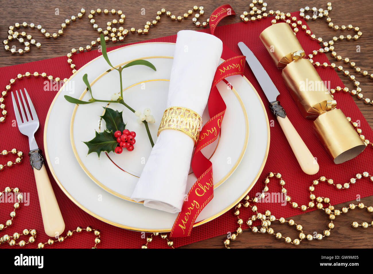 Christmas dinner table setting with white plates, antique cutlery ...