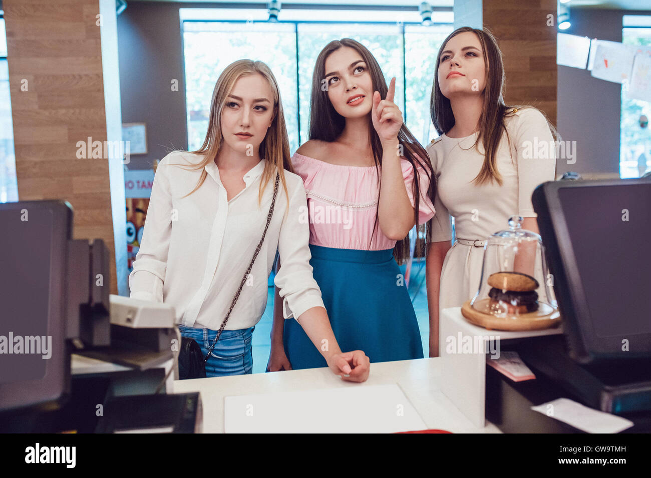 Three young girls make order in a fast food restaurant Stock Photo - Alamy