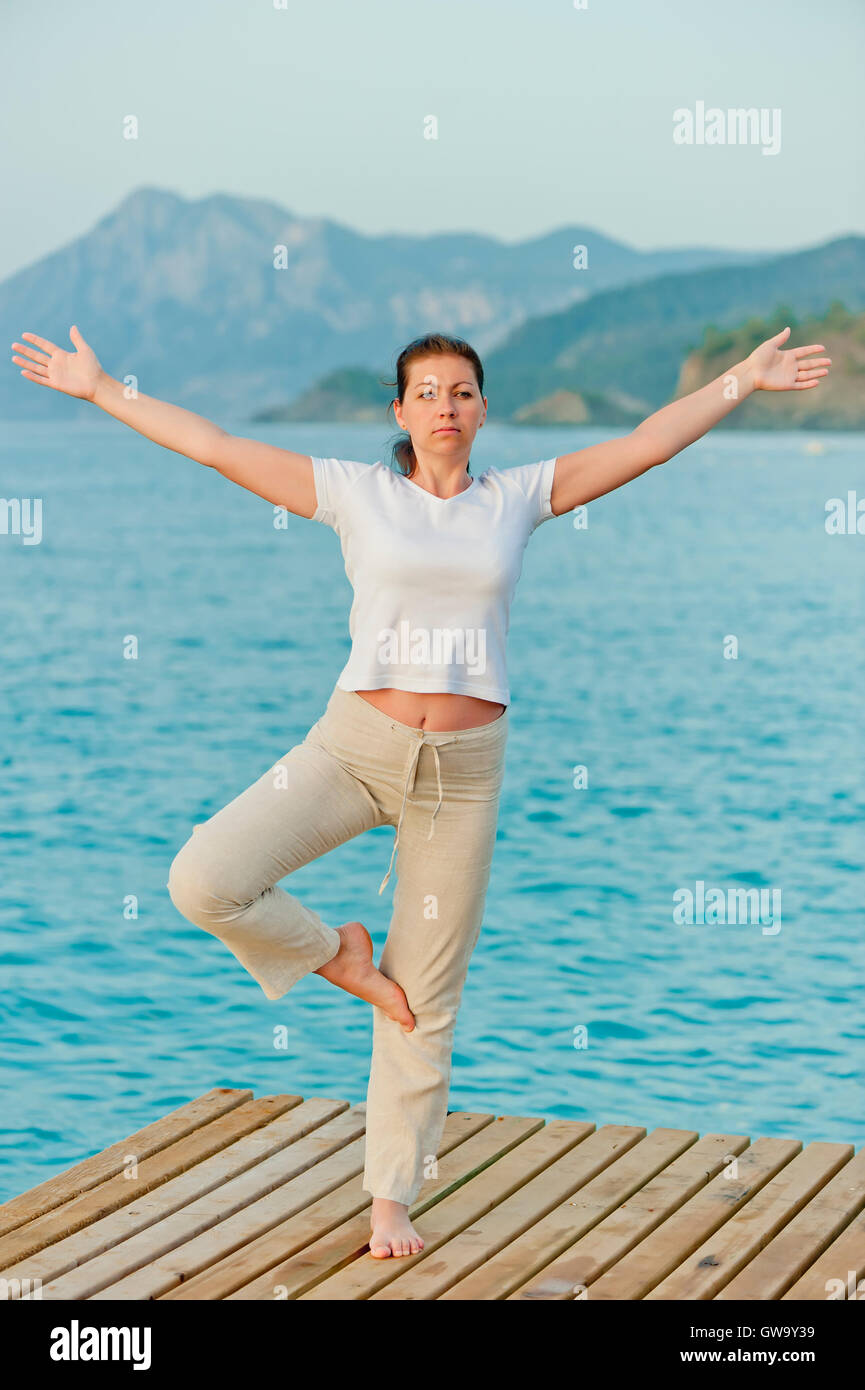 girl standing on one leg with arms outstretched to the sides Stock ...