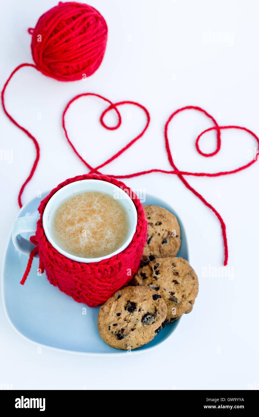 Blue cup with red knitted cover and the heart of the thread Stock Photo ...