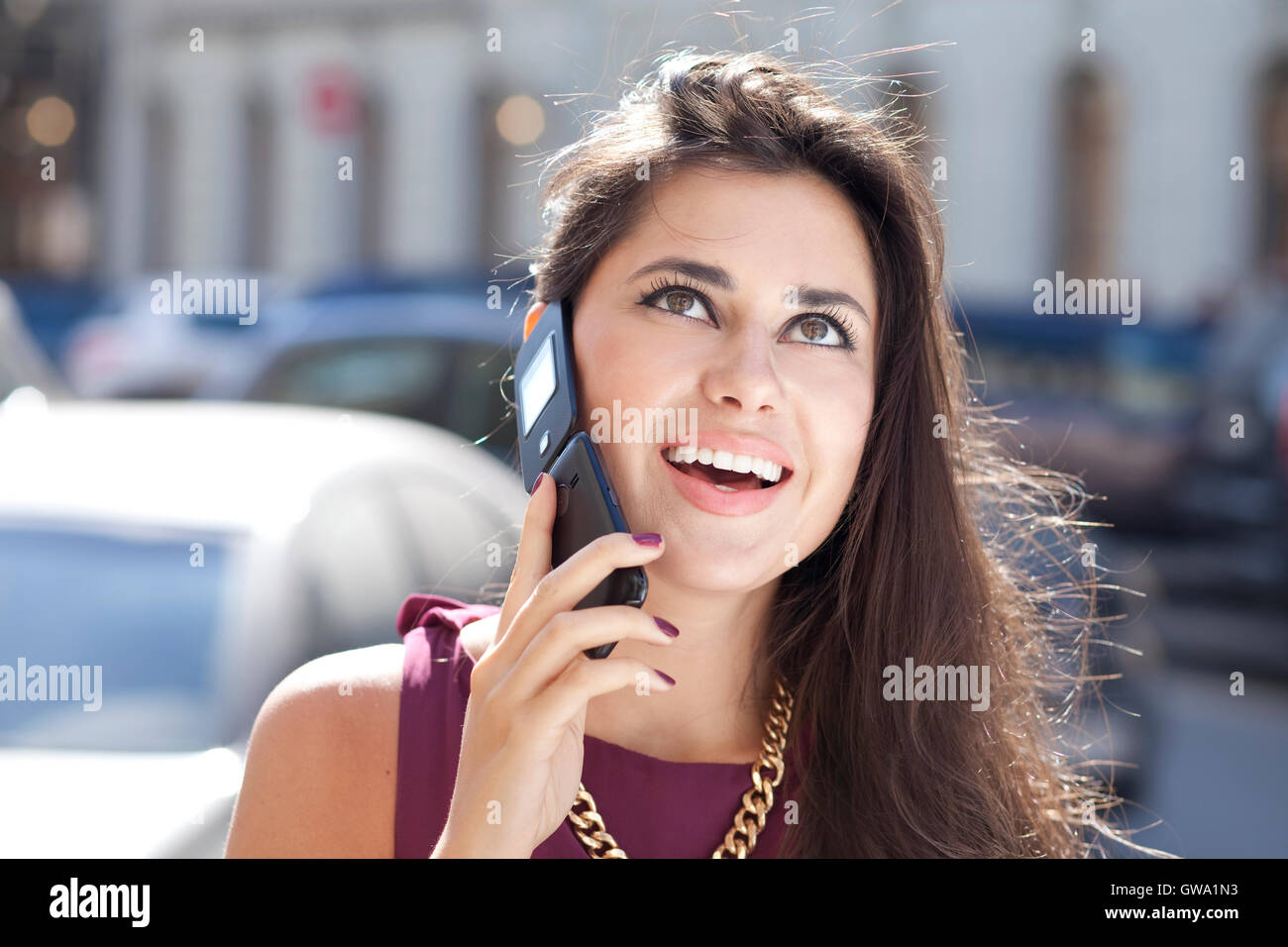 Young happy woman calling by phone on the street Stock Photo - Alamy