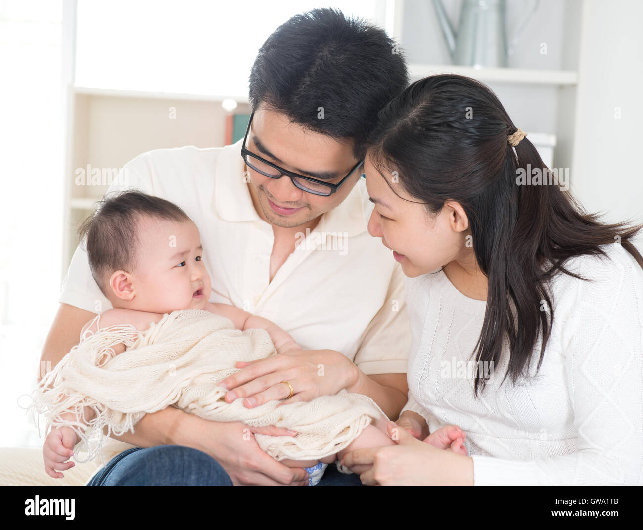 Parents pampering baby Stock Photo - Alamy