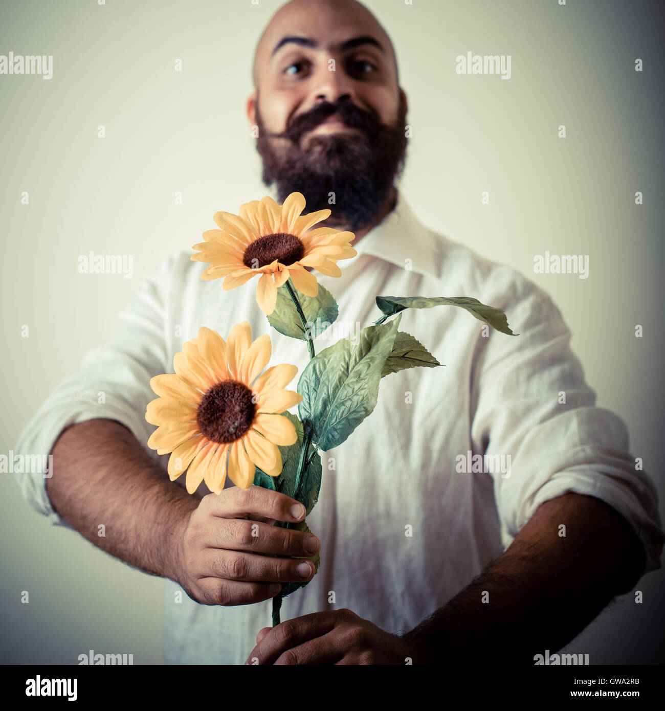 long beard and mustache man giving flowers Stock Photo - Alamy
