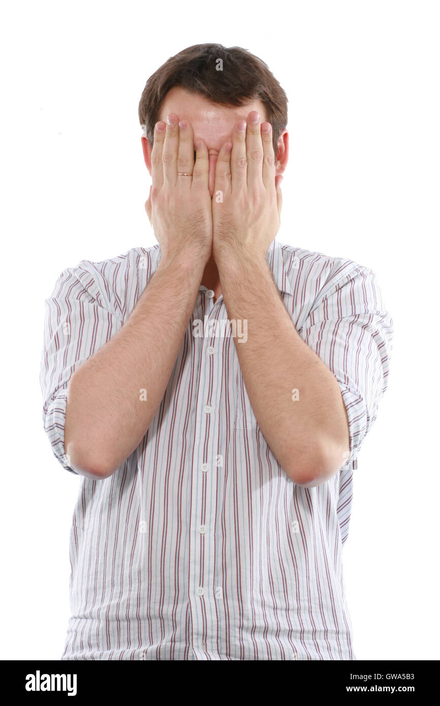 Desperate young man covering with his head in his hands Stock Photo - Alamy