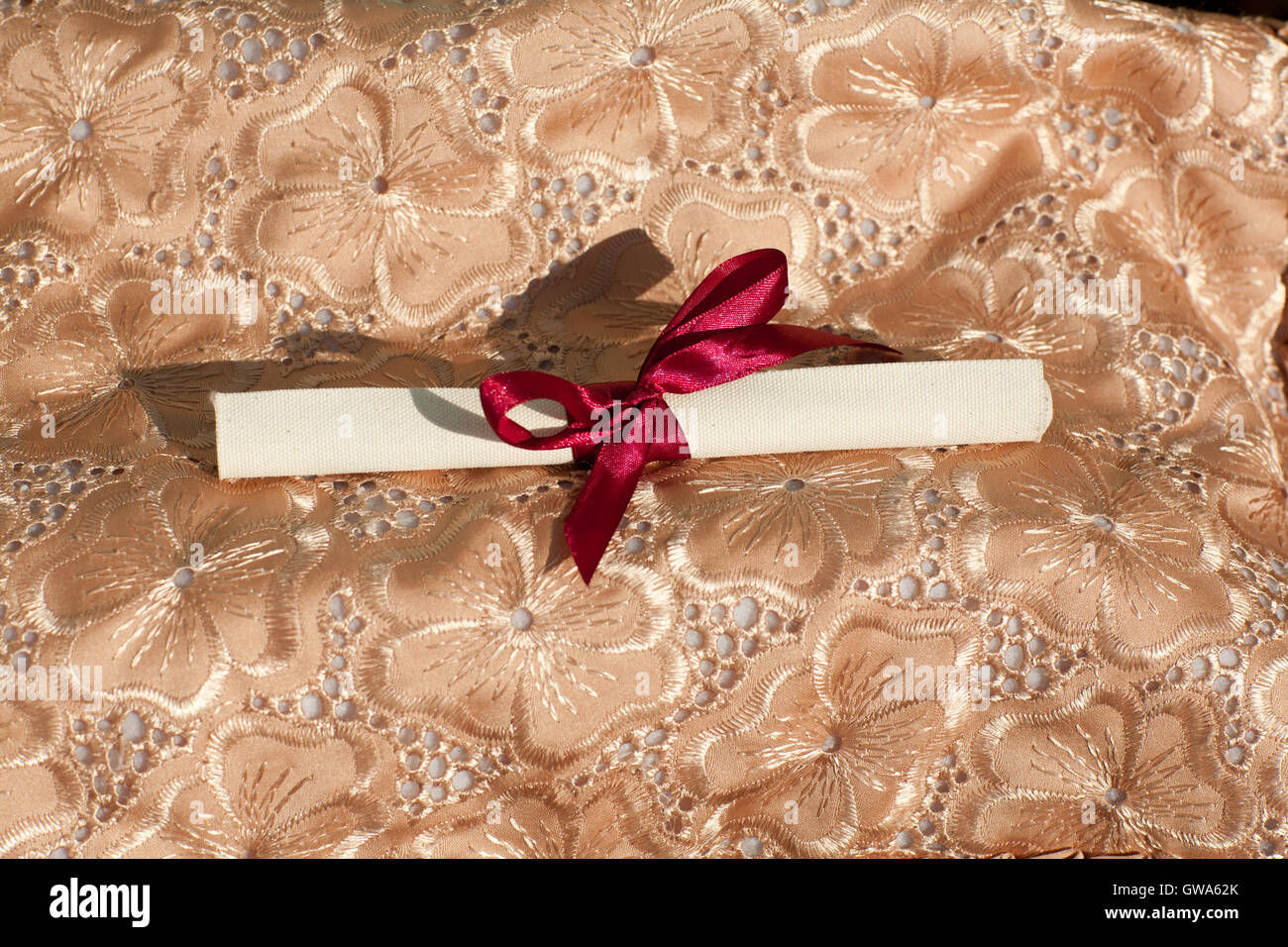 Scroll tied up by tape with a bow Stock Photo - Alamy