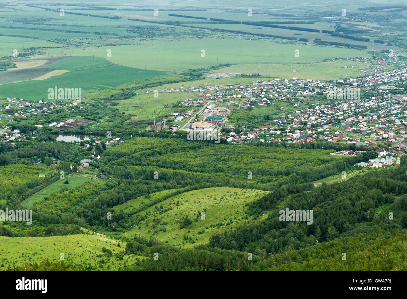 Aerial view of flat land with forests, agricultural fields, farms and ...