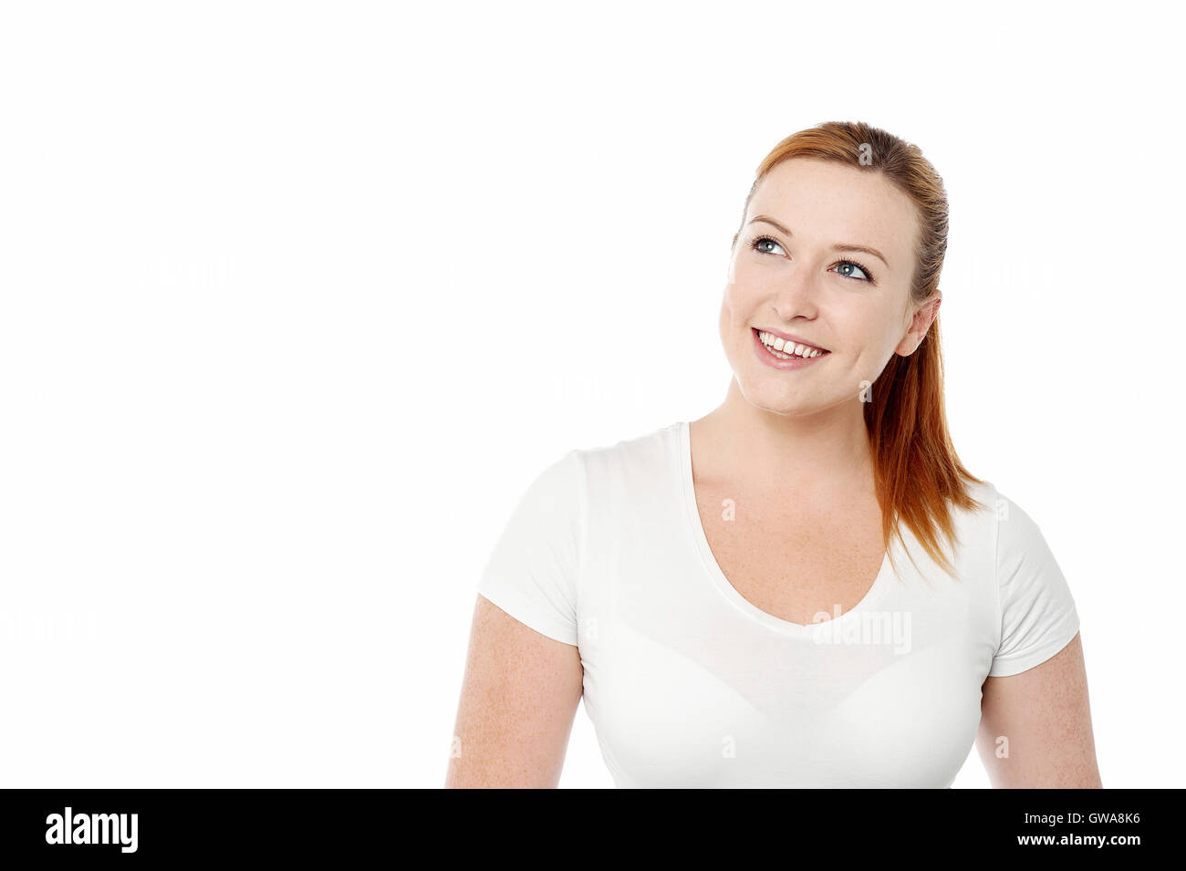Attractive young lady looking upwards Stock Photo - Alamy