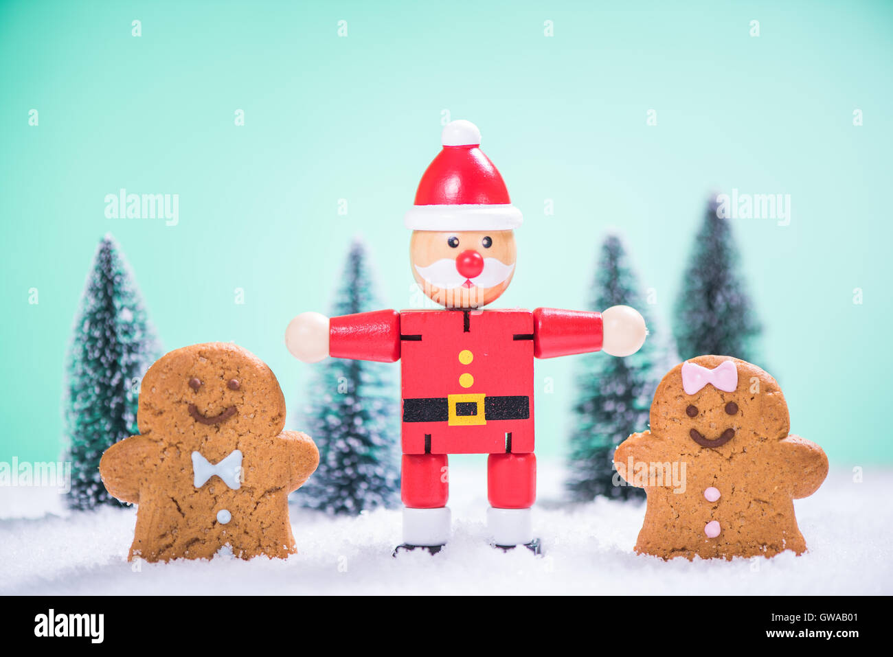Funny Santa and gingerbread kids in snow Stock Photo - Alamy