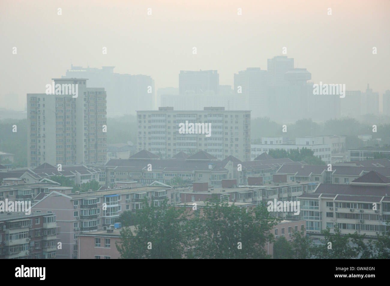 Apartment buildings rising up above the streets in the pollution filled ...