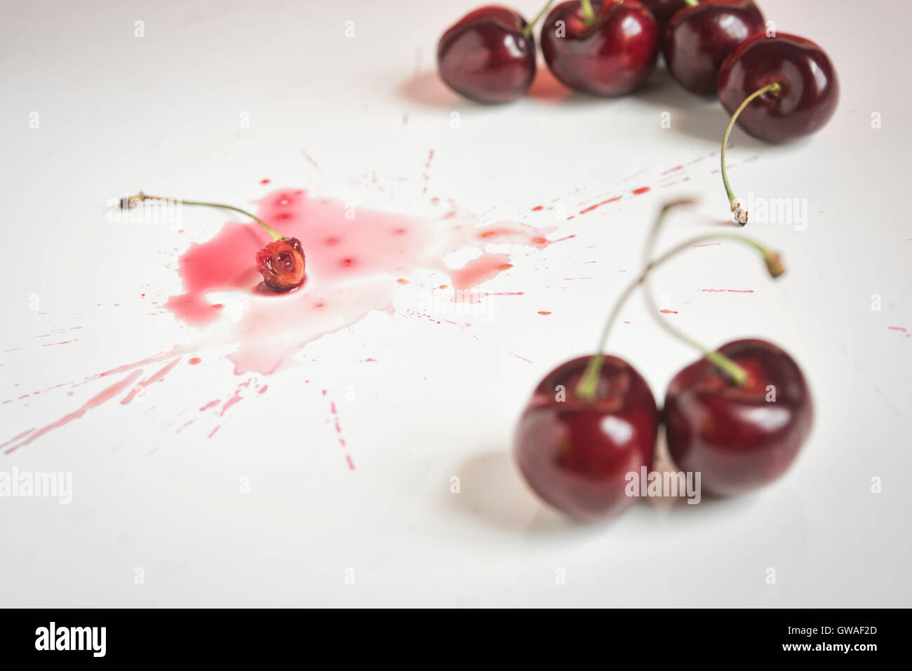 Smashed cherry on white Stock Photo - Alamy