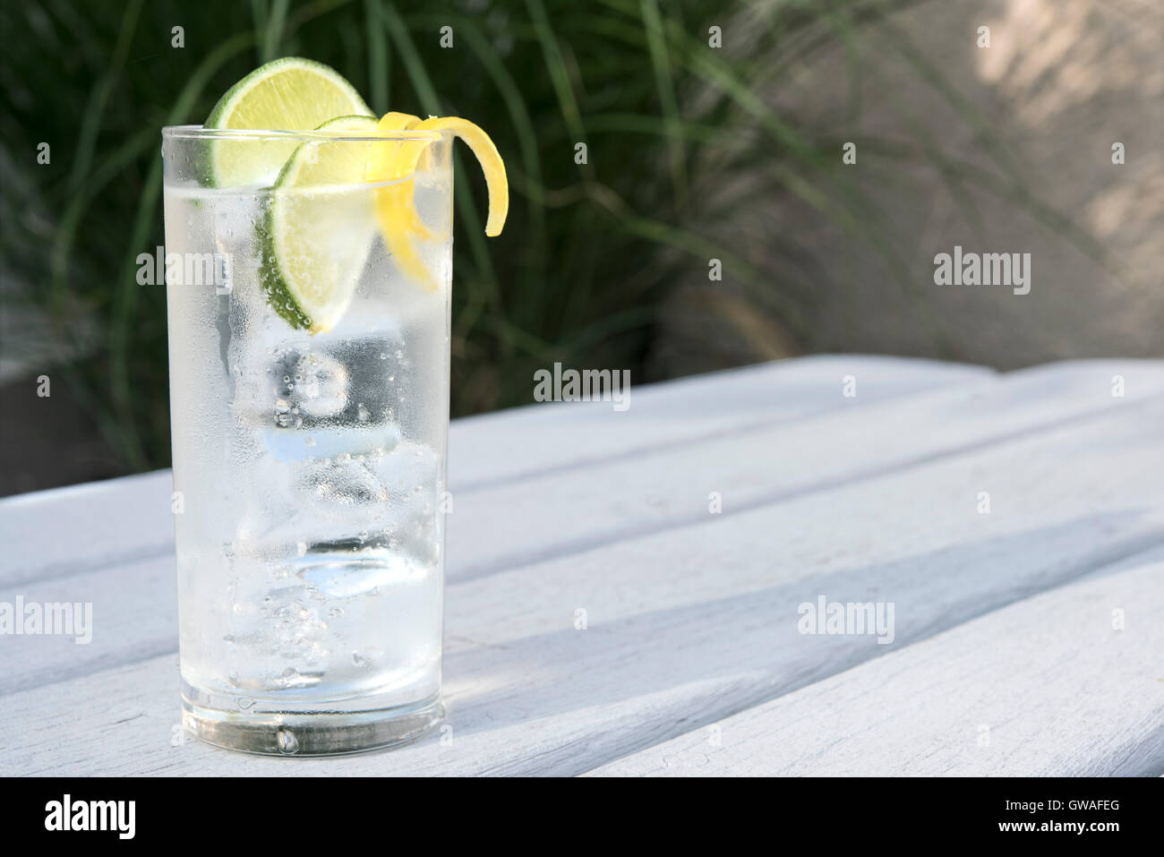 Ice water on wooden white table outdoors Stock Photo - Alamy